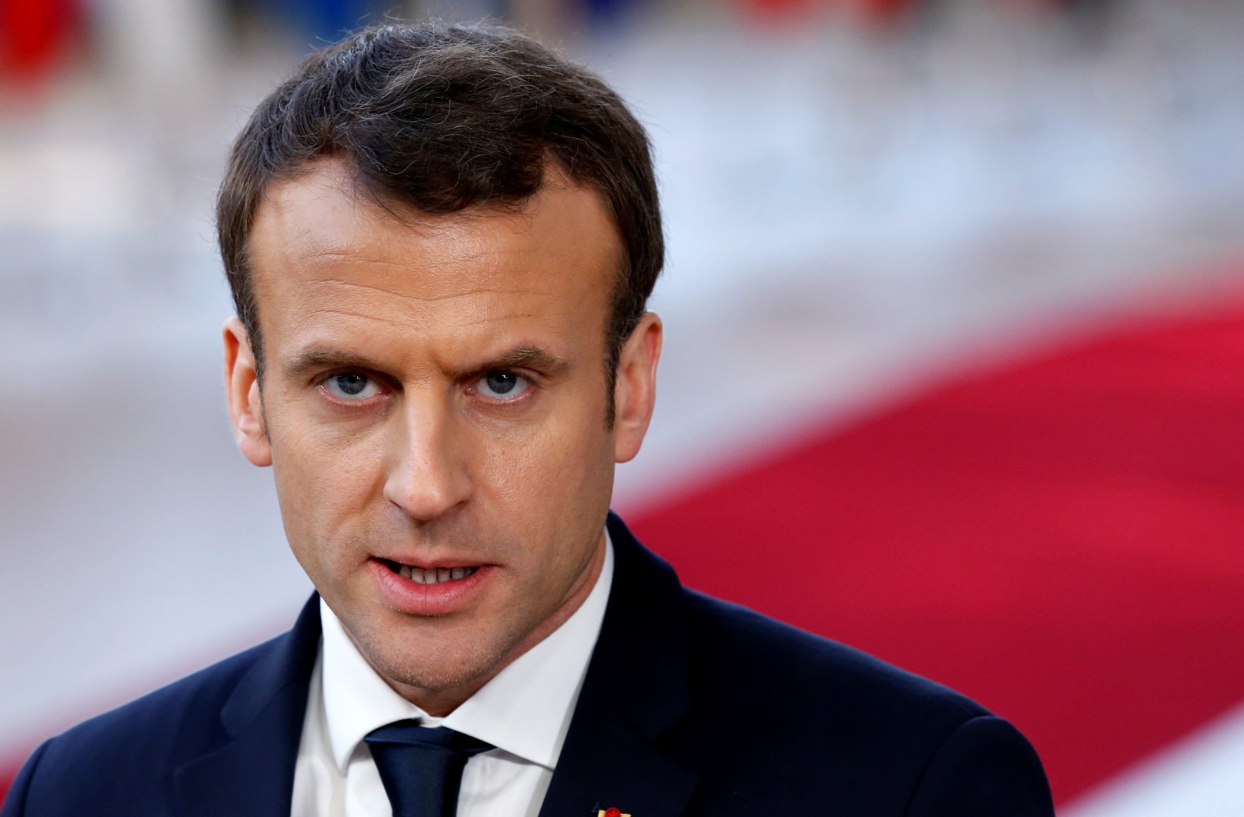 French President Emmanuel Macron briefs the media as he arrives at a ... French President Emmanuel Macron briefs the media as he arrives at a ...